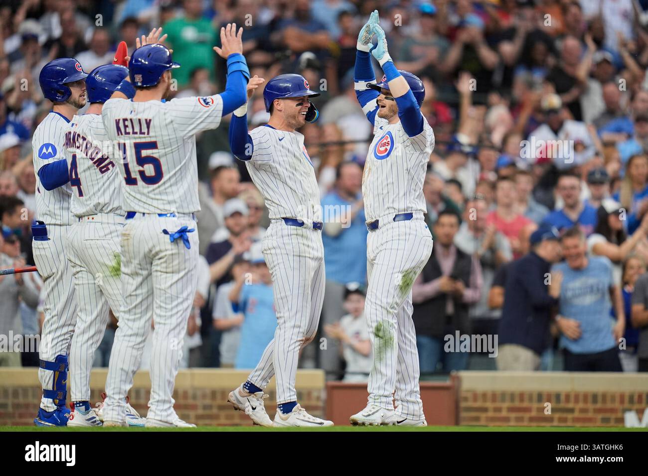 Chicago Cubs' Ian Happ, right, high-fives Nico Hoerner after hitting a ...