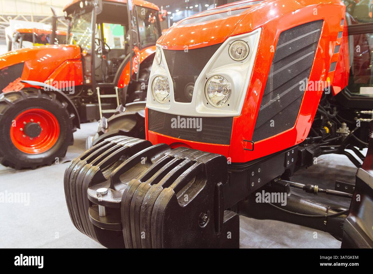 New agricultural tractors are sold for work in the field. Mechanical ...