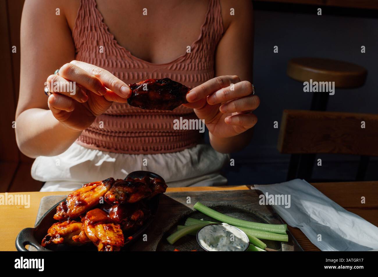 Woman holding chicken wing hi-res stock photography and images - Alamy