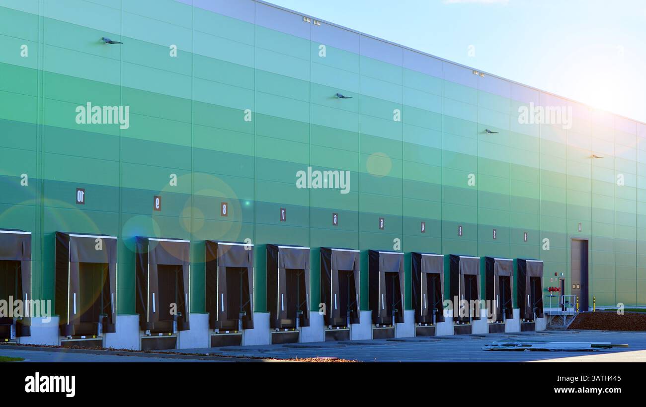 Facade of an industrial building and warehouse. Empty platforms at a ...