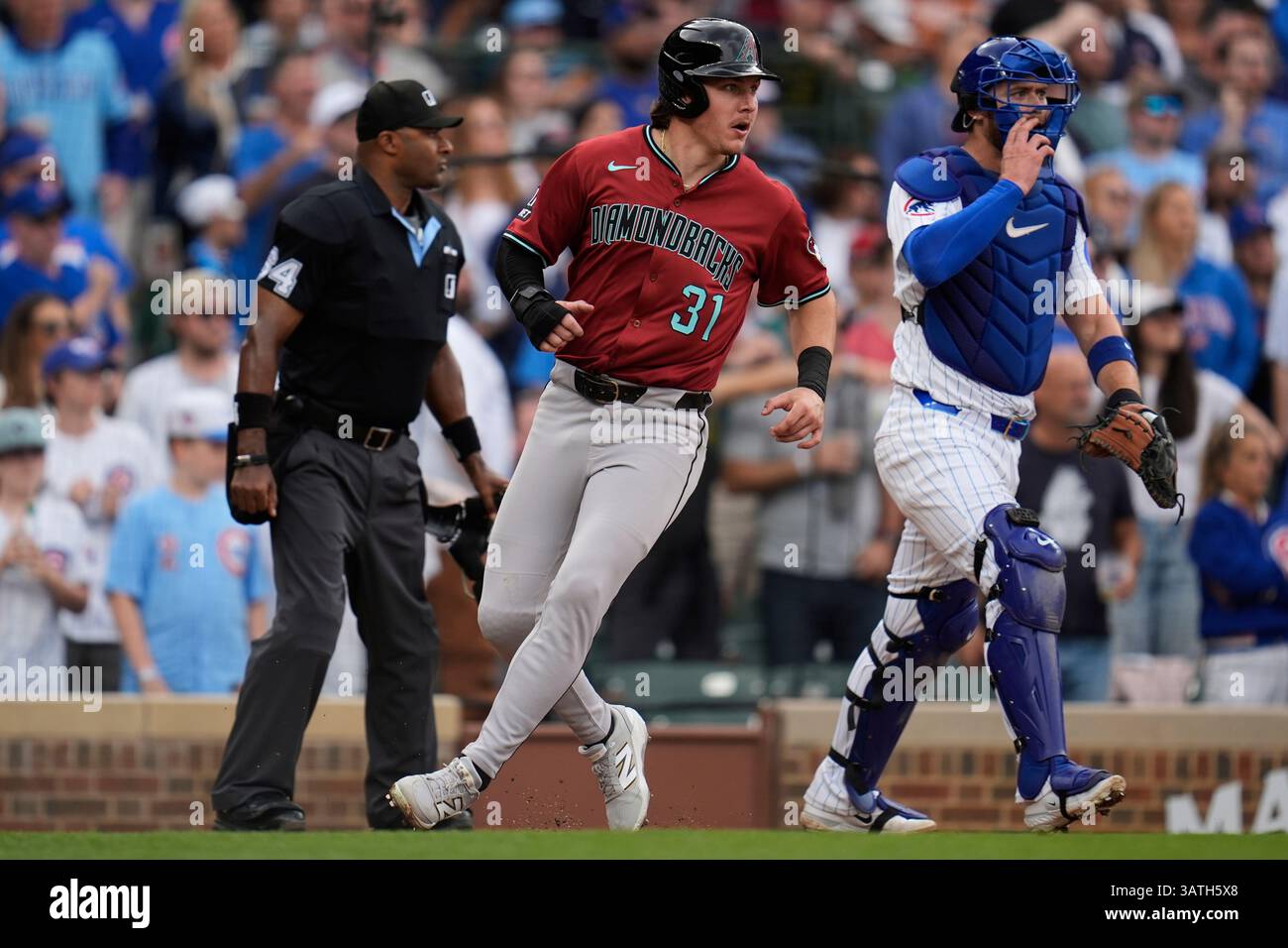 Arizona Diamondbacks' Jake McCarthy (31) scores on a single by Geraldo ...