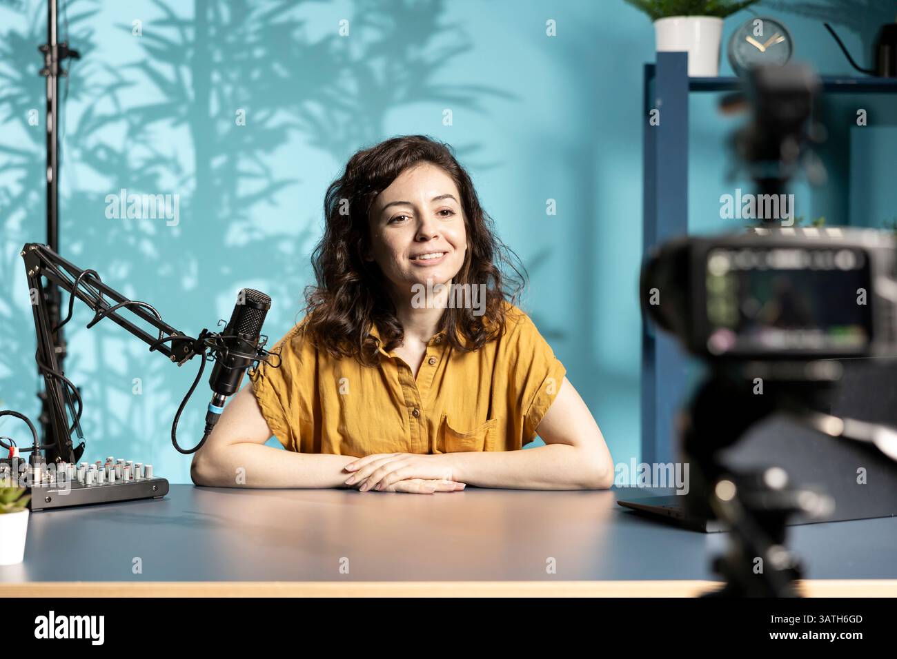 Cheerful content creator using high tech quality mic in studio to do ...