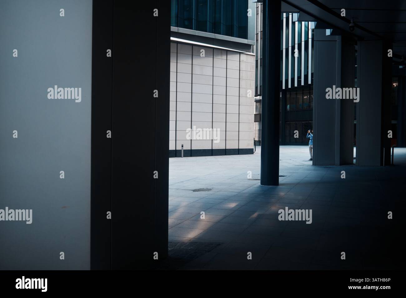 London, UK - September 28, 2024: A shaded architectural passage opens ...