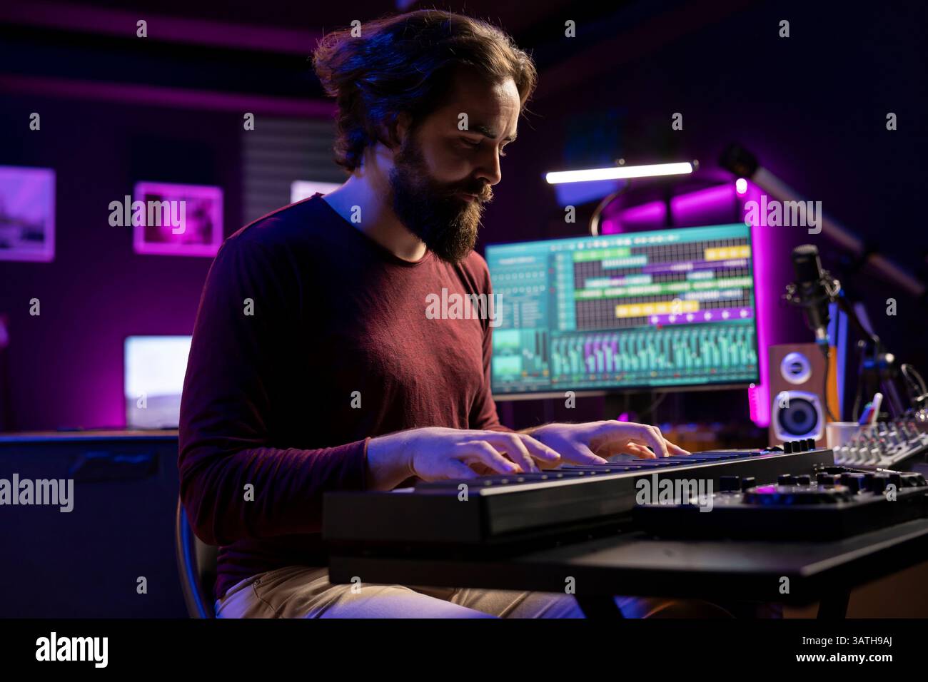 Skilled artist creating new music on electronic midi controller in home ...