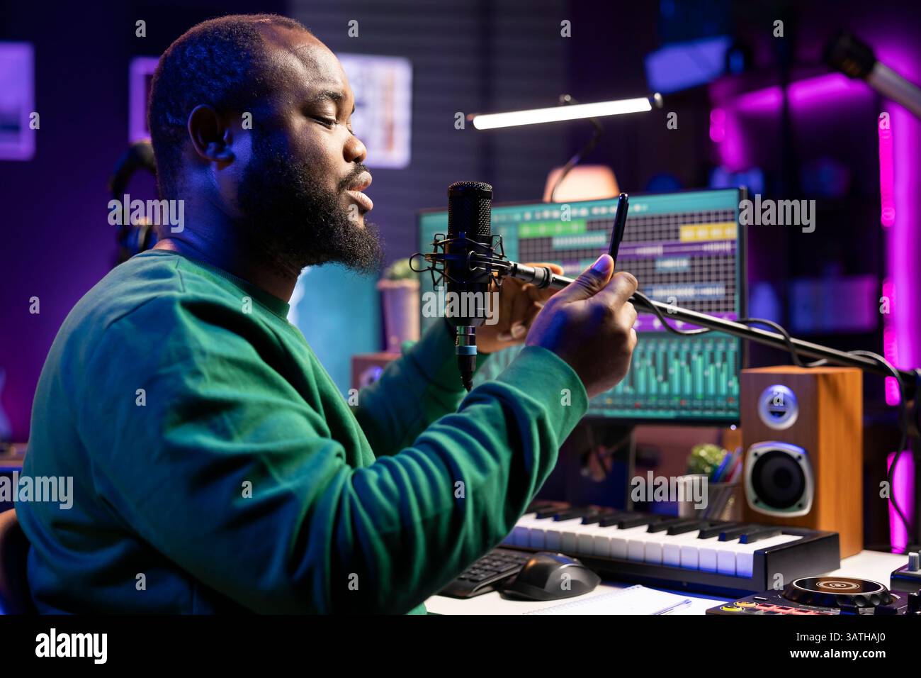 Artist songwriter performing his new musical creation in home studio ...