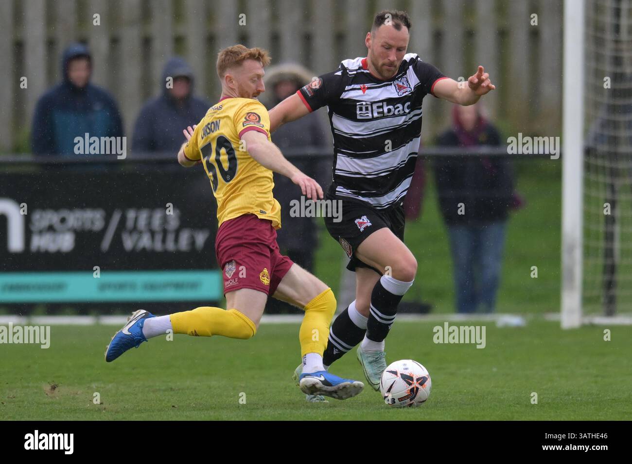 Darlington FC Louis Storey looks to block South Shields David Carson ...
