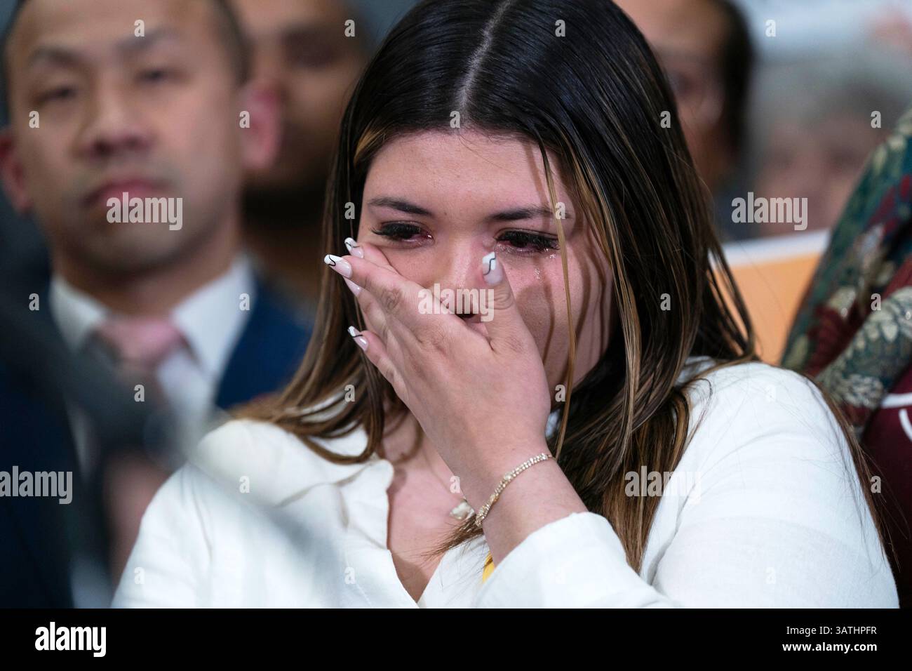 Jennifer Vasquez Sura wipes a tear from her face as Sen. Chris Van ...