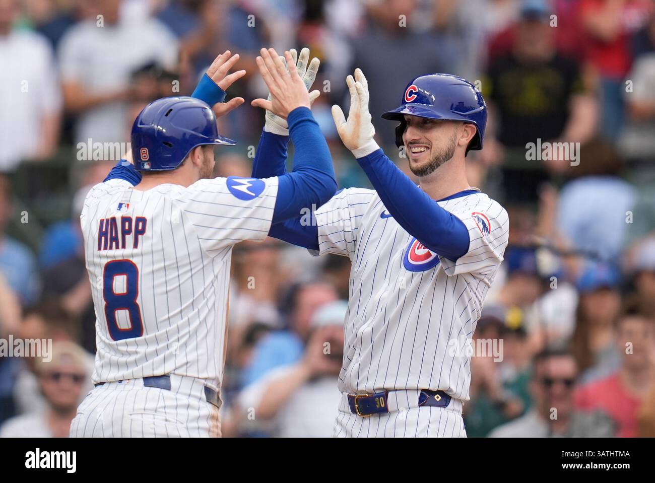 Chicago Cubs' Kyle Tucker (30), right, high-fives Ian Hapy after Tucker ...