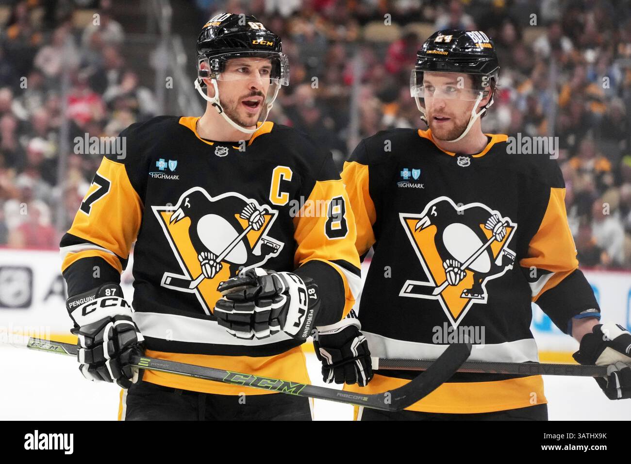 Pittsburgh Penguins' Sidney Crosby prepares to take a face-off with Matt Grzelcyk (24) during ...
