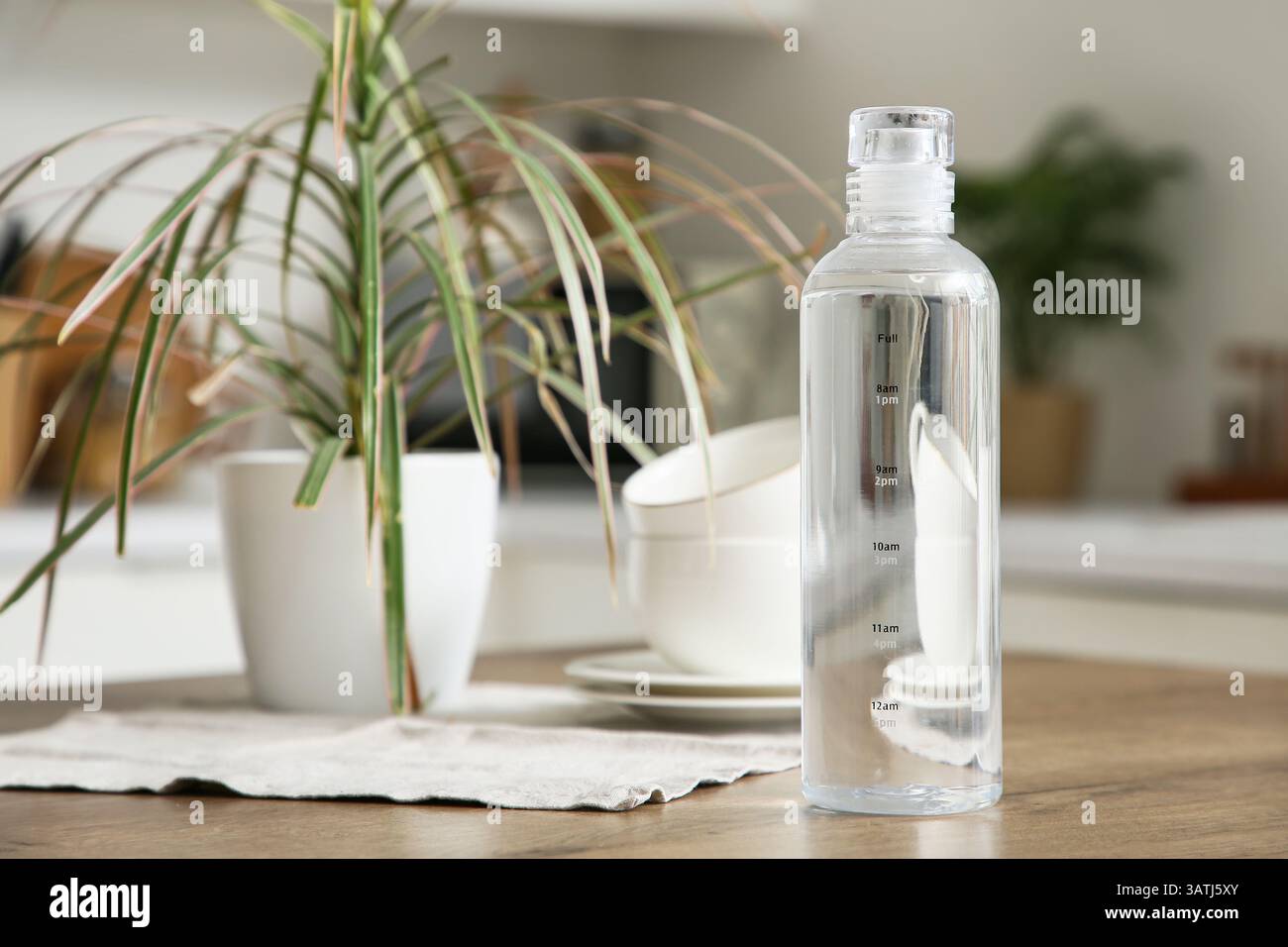 Bottle of water with time stamps on table in kitchen, closeup Stock ...
