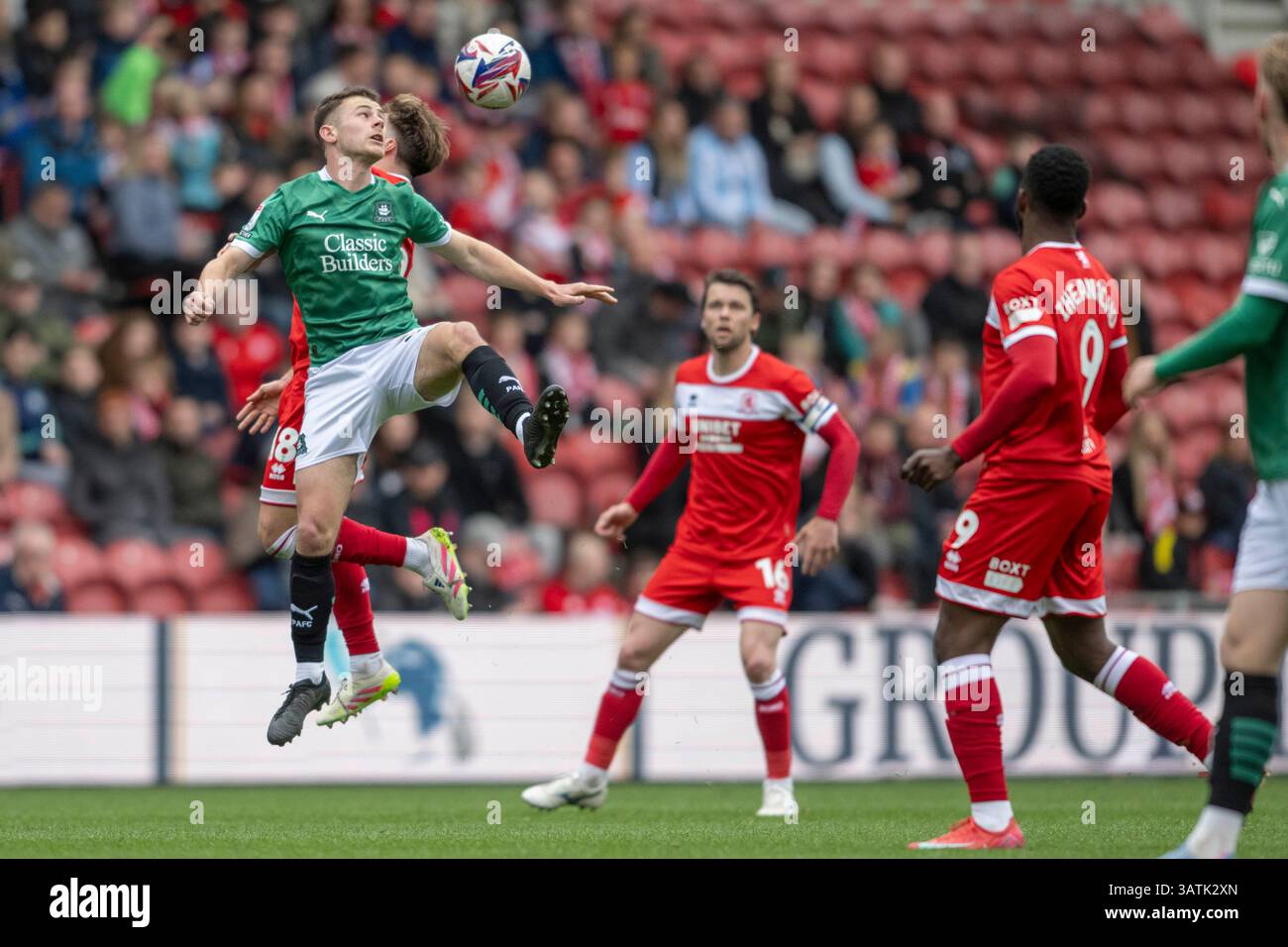 Plymouth Argyle's Adam Randell heads the ball under pressure from ...