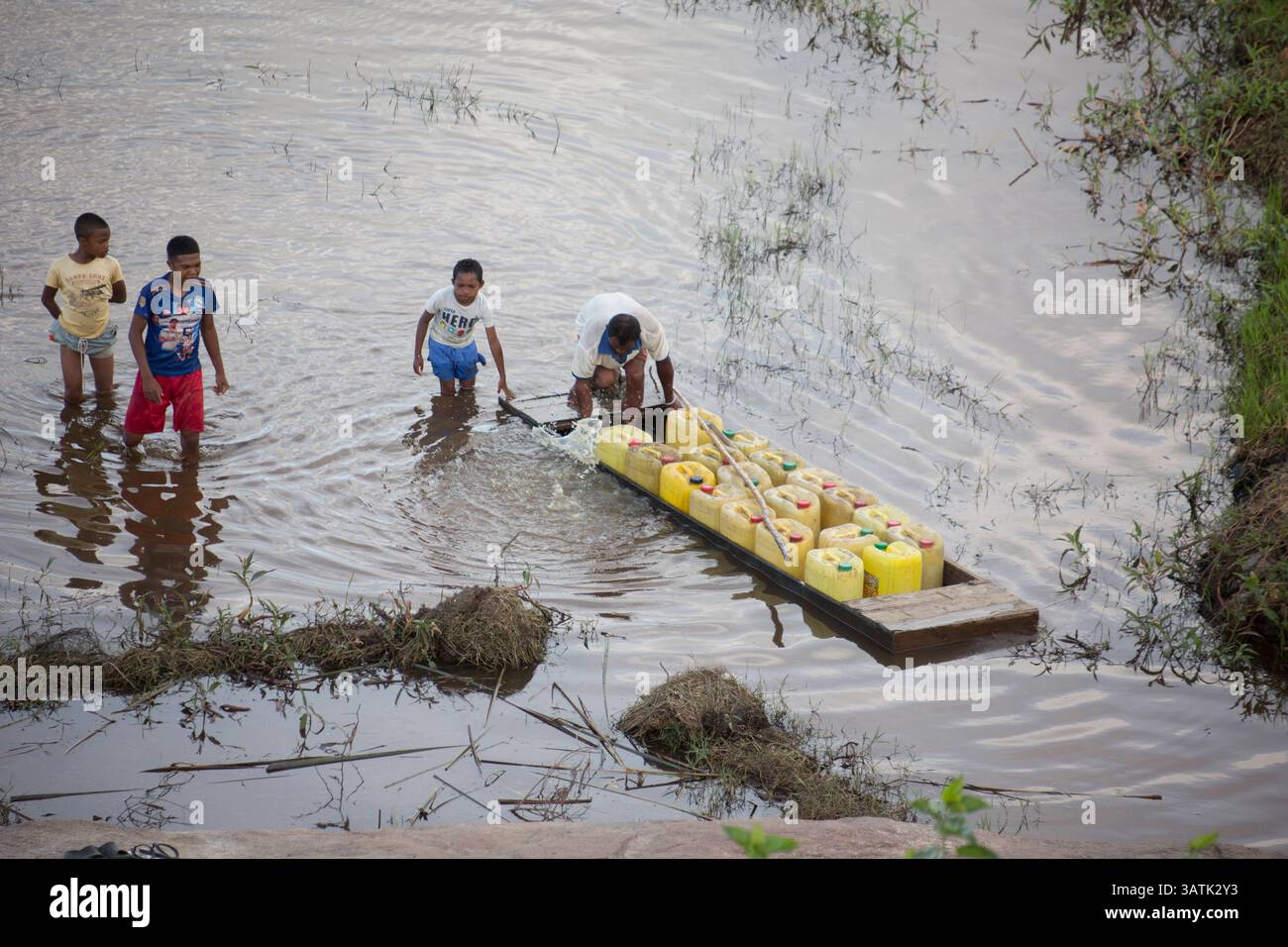Water management in Madagascar A man bails water from a boat after ...