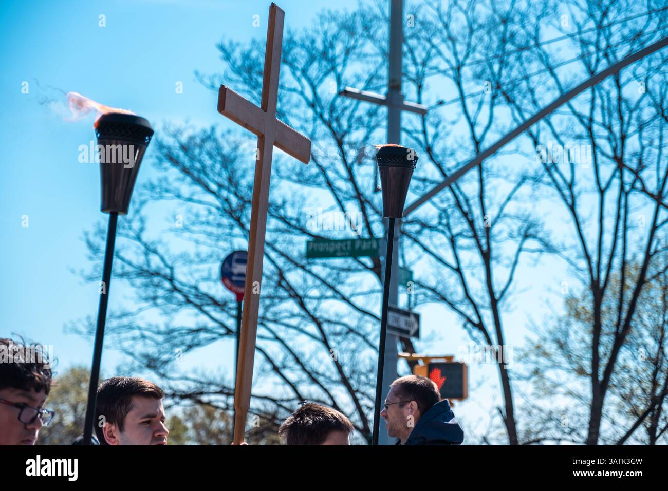 Cross and torches seen at the front of the procession. Parishioners of ...