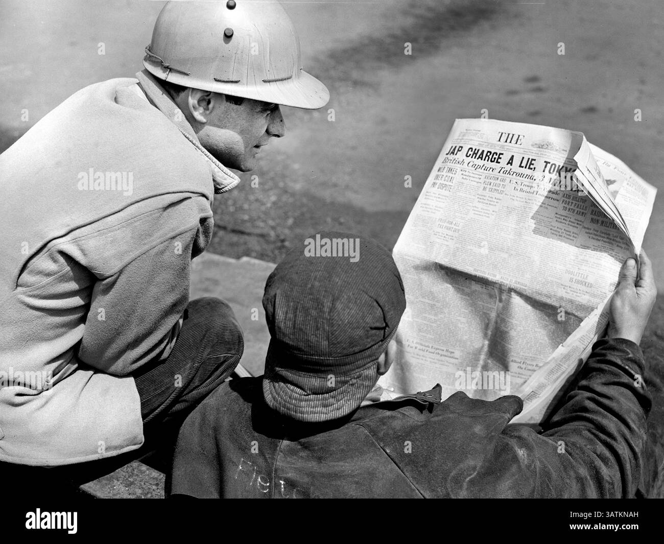 Two factory workers reading the Baltimore Sun newspaper during lunch ...