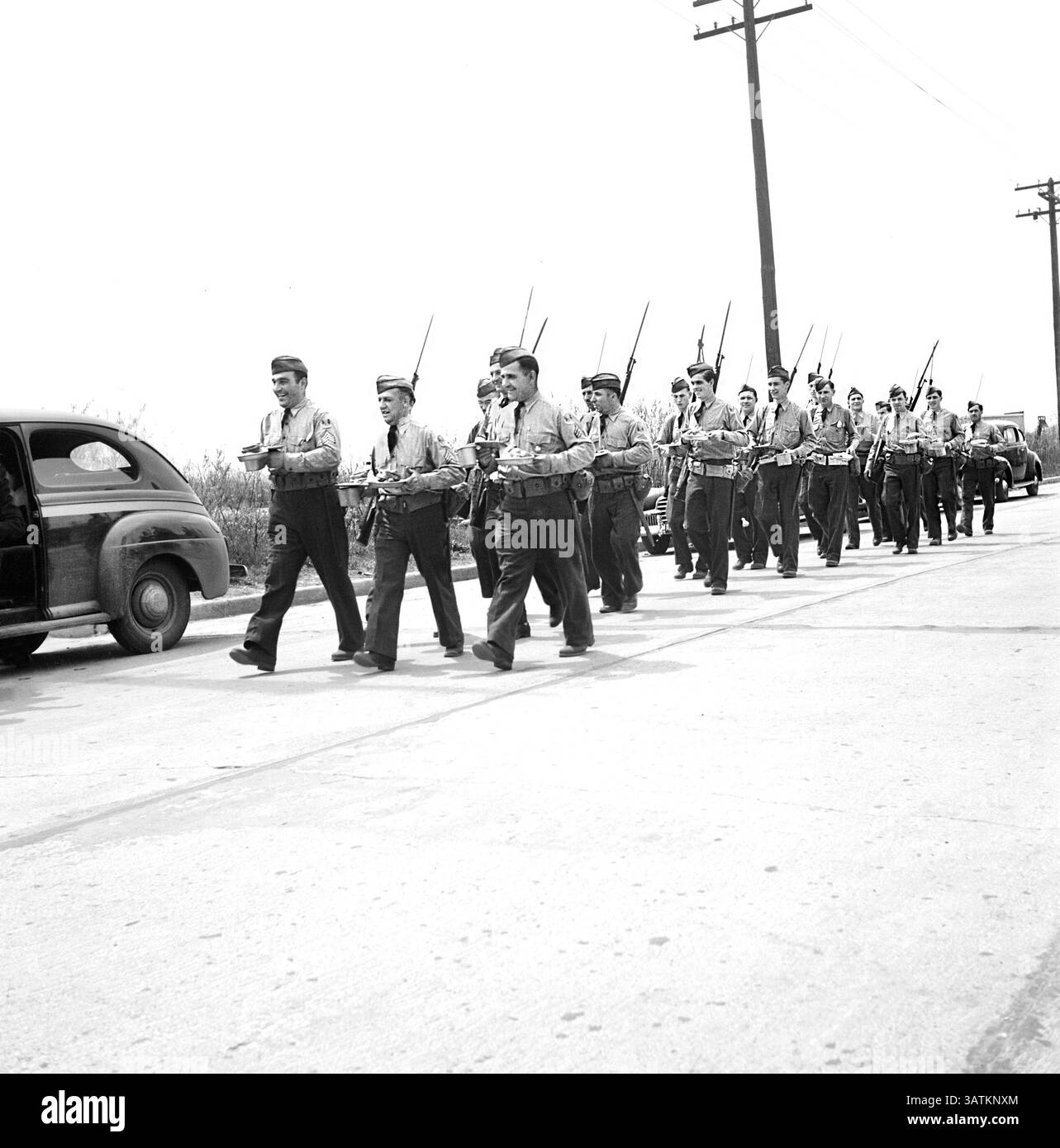Home guard troops, with bared bayonets, carrying mess kits at Sojourner ...