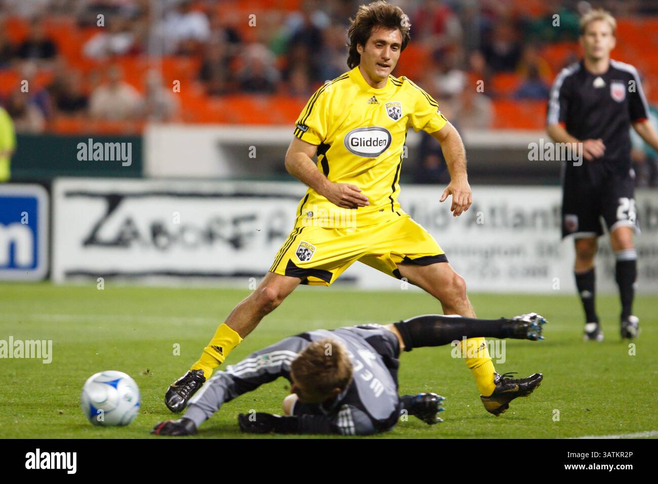 Guillermo Barros Schelotto of the Columbus Crew is blocked by DC United ...