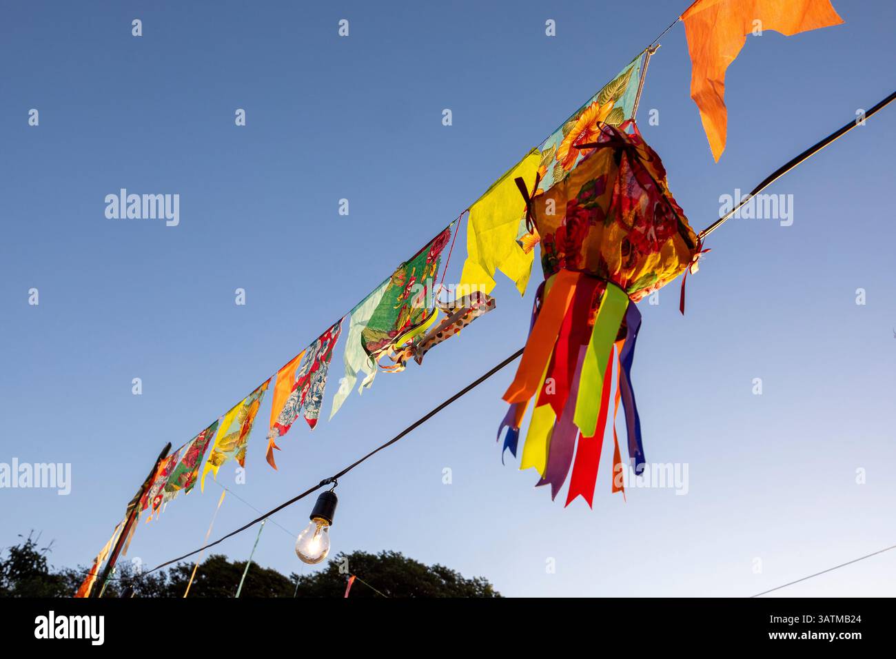 Balloons and hanging flags form a multicolored scene and decorate an ...