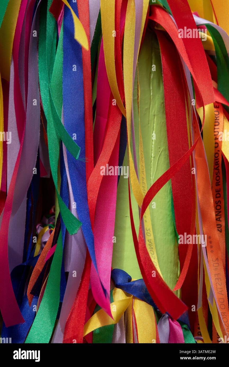 closeup of multicolored ribbons tied to a pole symbolizing the desires ...