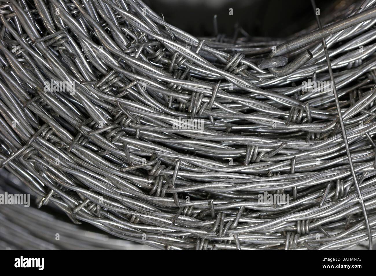 Close up of roll of barbed wire Stock Photo - Alamy