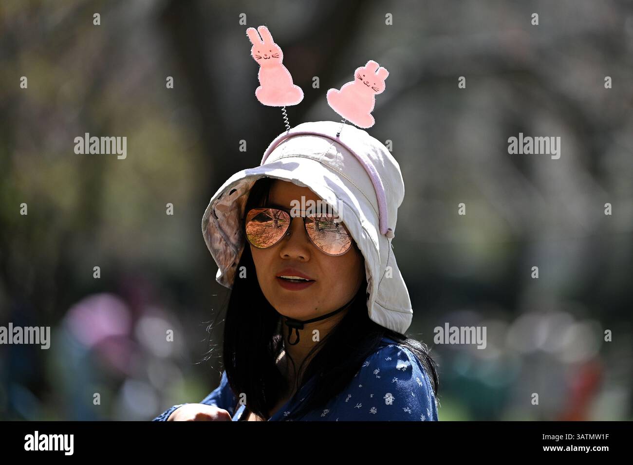 New York, USA. 18th Apr, 2025. A woman wears a headband with bunnies ...