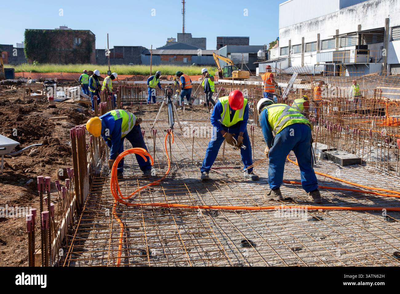 Construction workers during installation of steel gratings for the ...