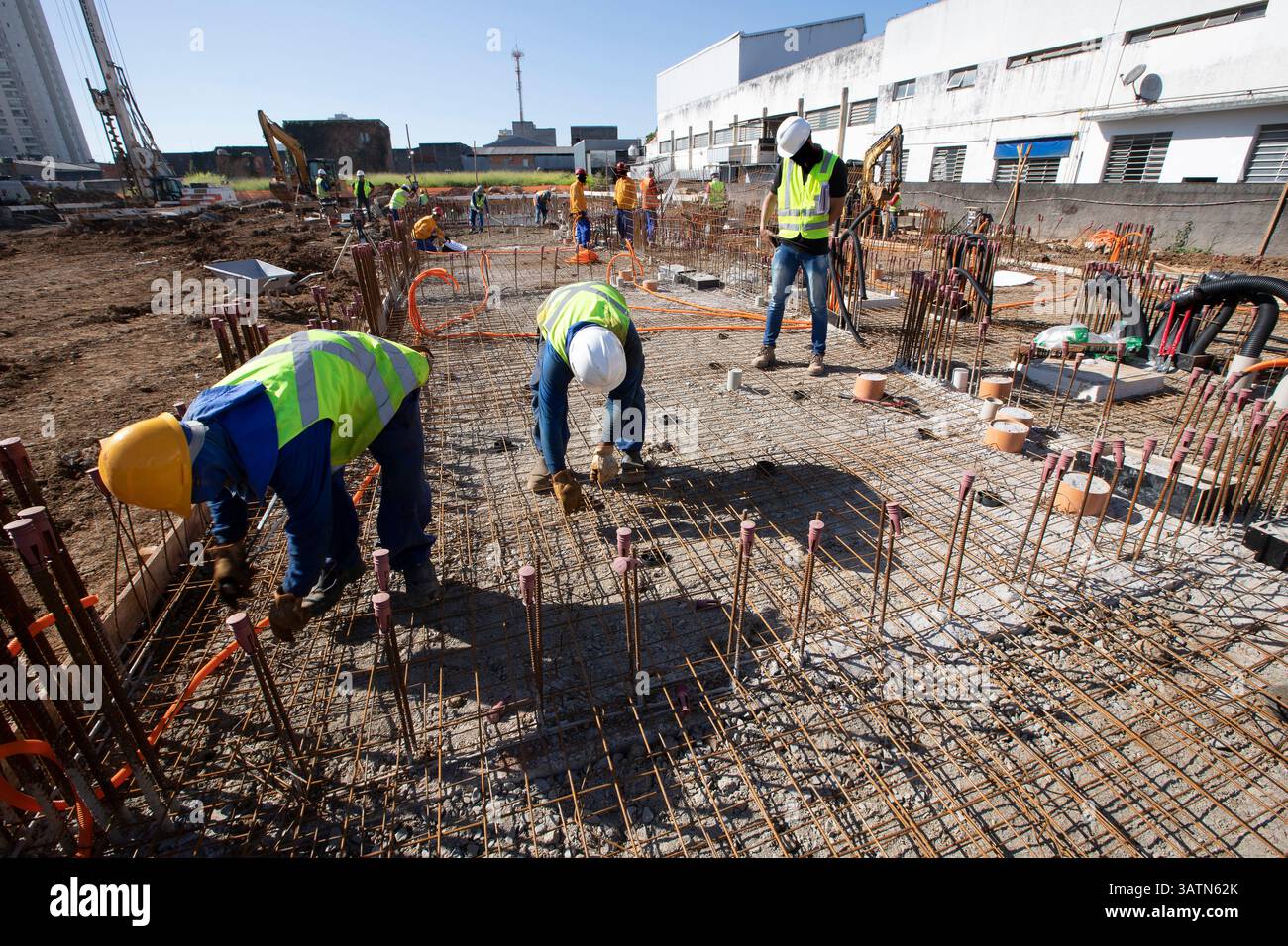 Construction workers during installation of steel gratings for the ...
