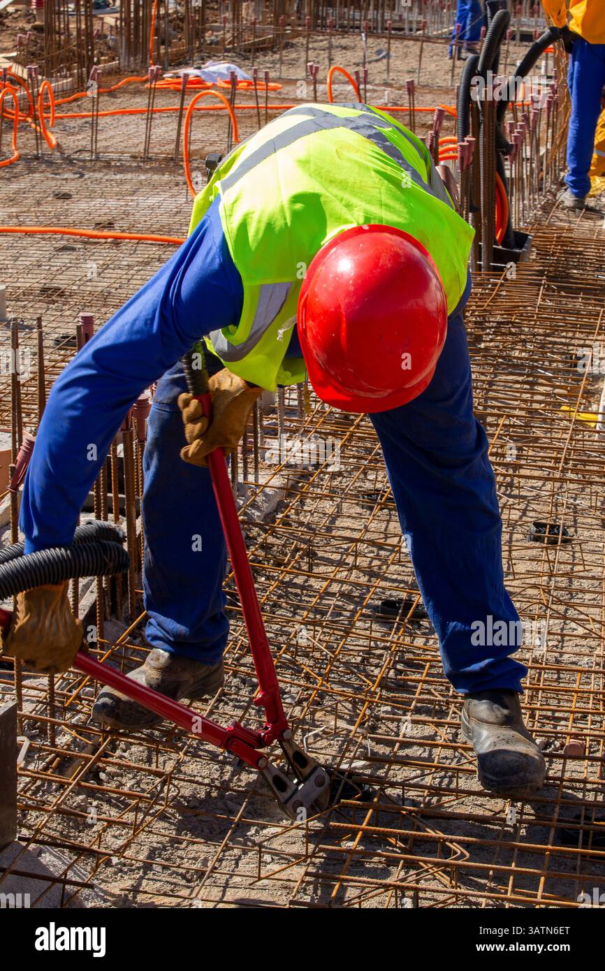 Construction workers during installation of steel gratings for the ...