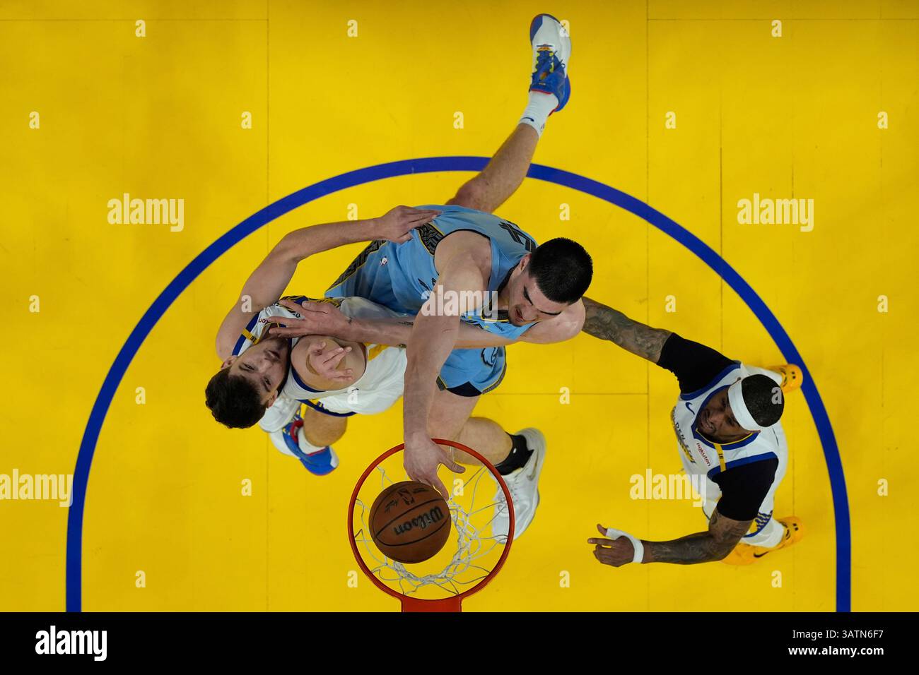 Memphis Grizzlies center Zach Edey, middle, misses a dunk between ...