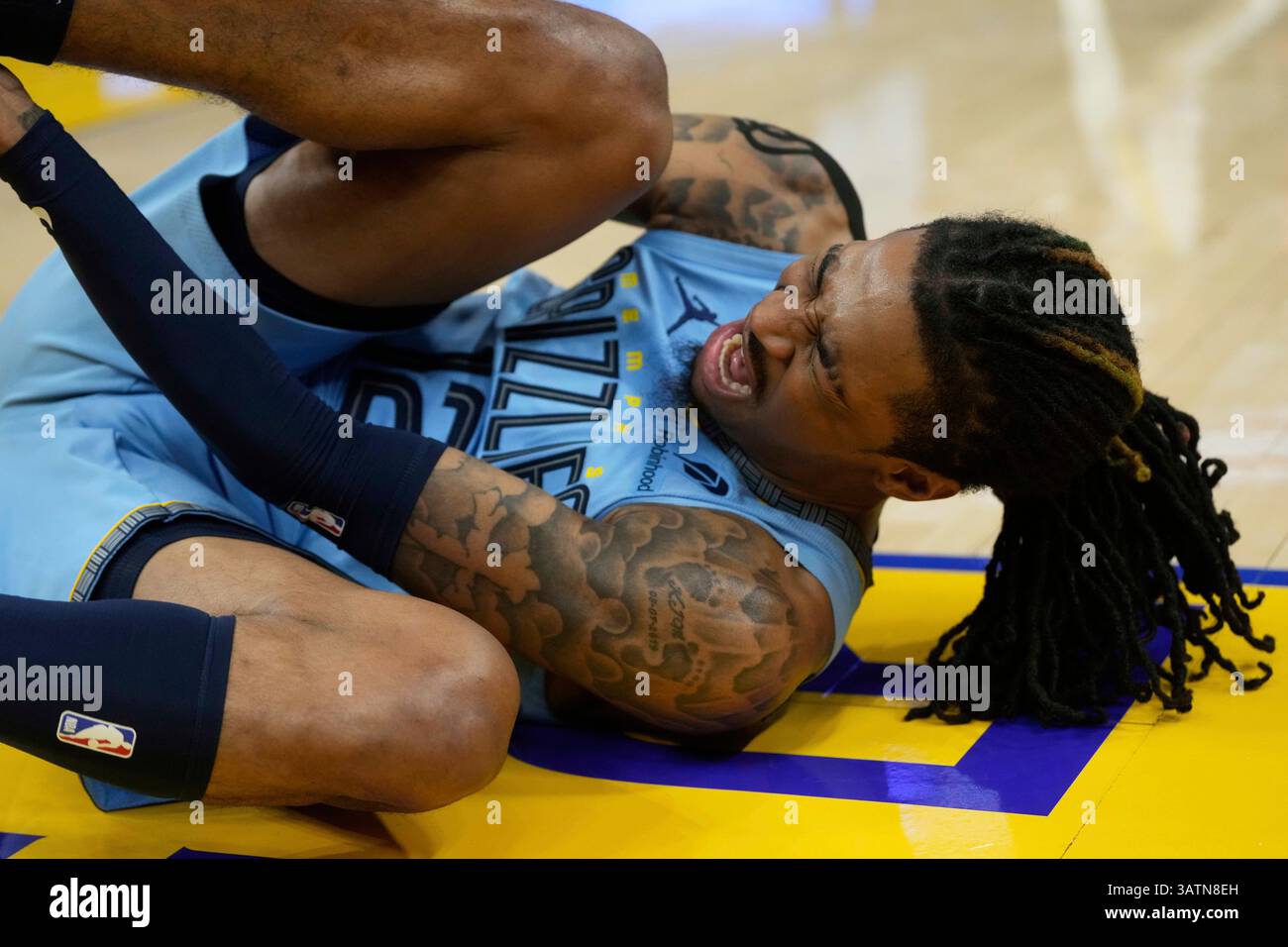 Memphis Grizzlies guard Ja Morant reacts after hitting the floor during ...