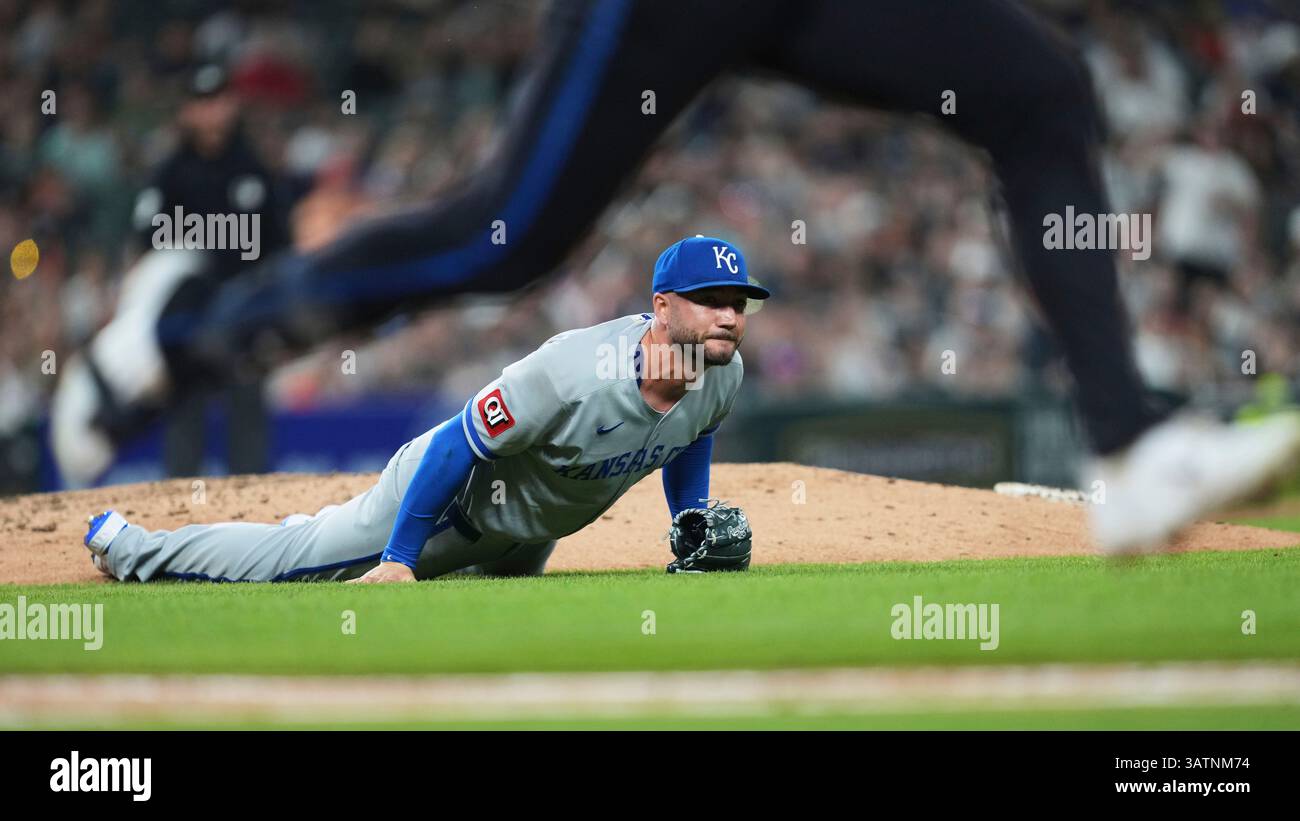 Kansas City Royals pitcher Lucas Erceg falls to the ground after being ...