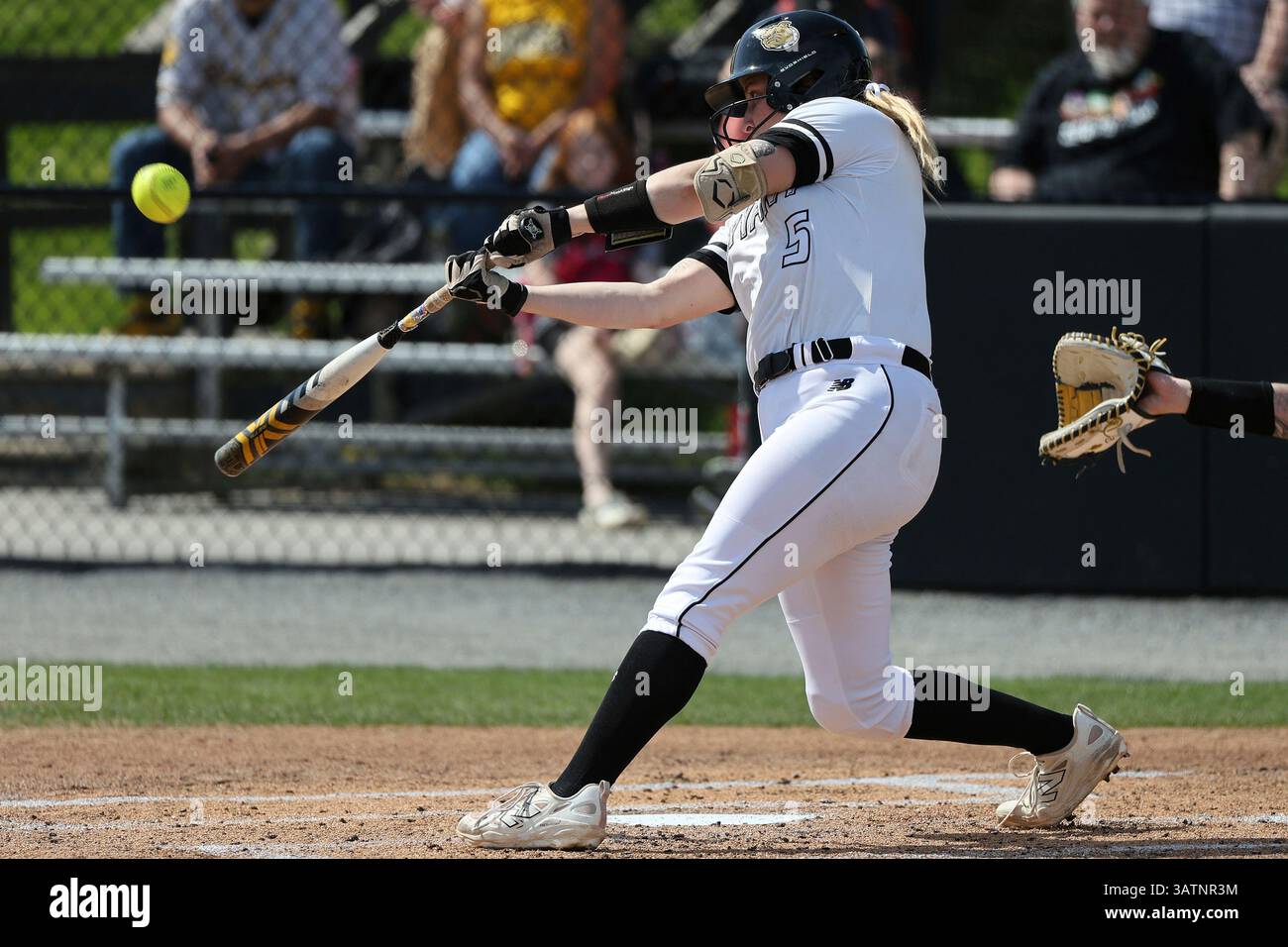 Bryant infielder Meaghan Houk (5) takes a swing during an NCAA softball ...