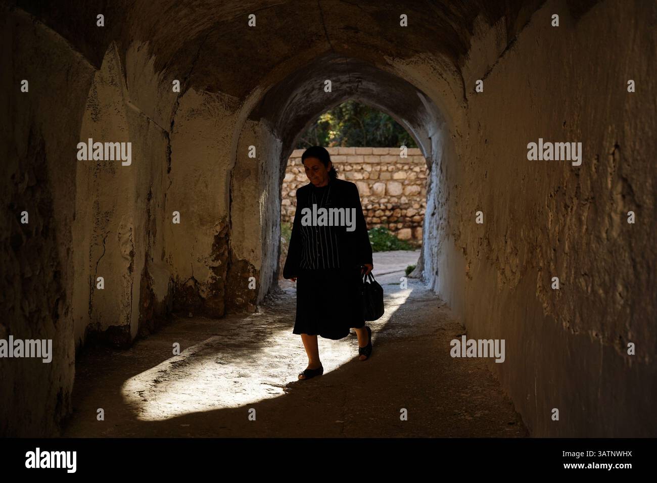 A Christian woman walks towards the Good Friday procession at Mar ...