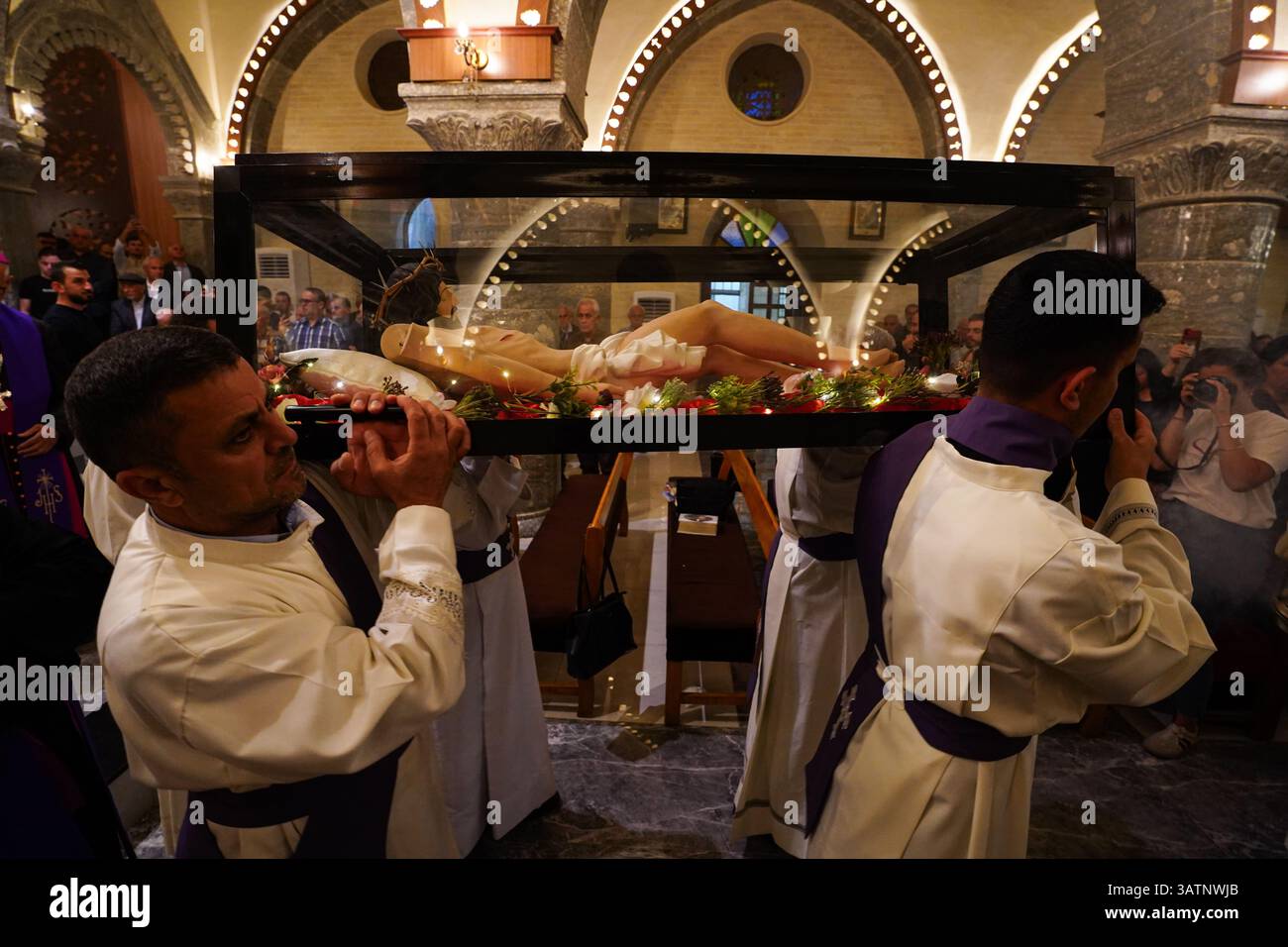 Alqosh, Iraq. 18th Apr, 2025. Clergy carry the coffin of Christ during ...