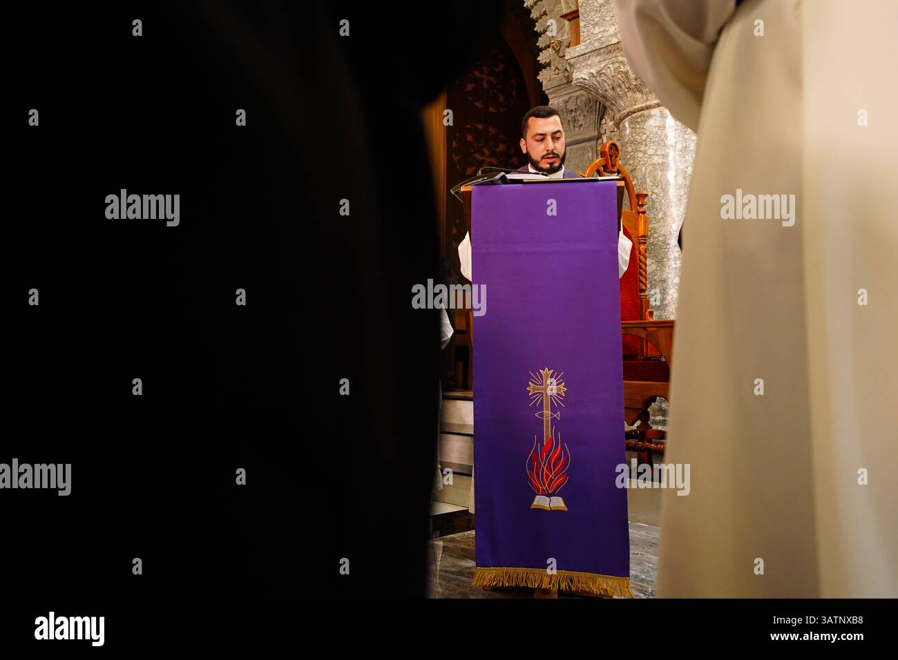 A priest attends the Good Friday procession at Mar Gorgis Chaldean ...