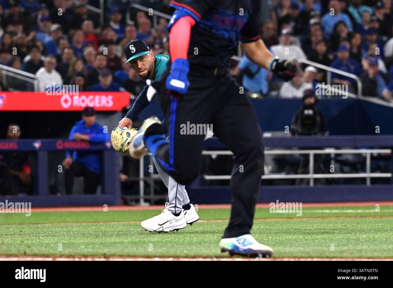 Seattle Mariners relief pitcher Casey Lawrence, left, fields a ball off ...