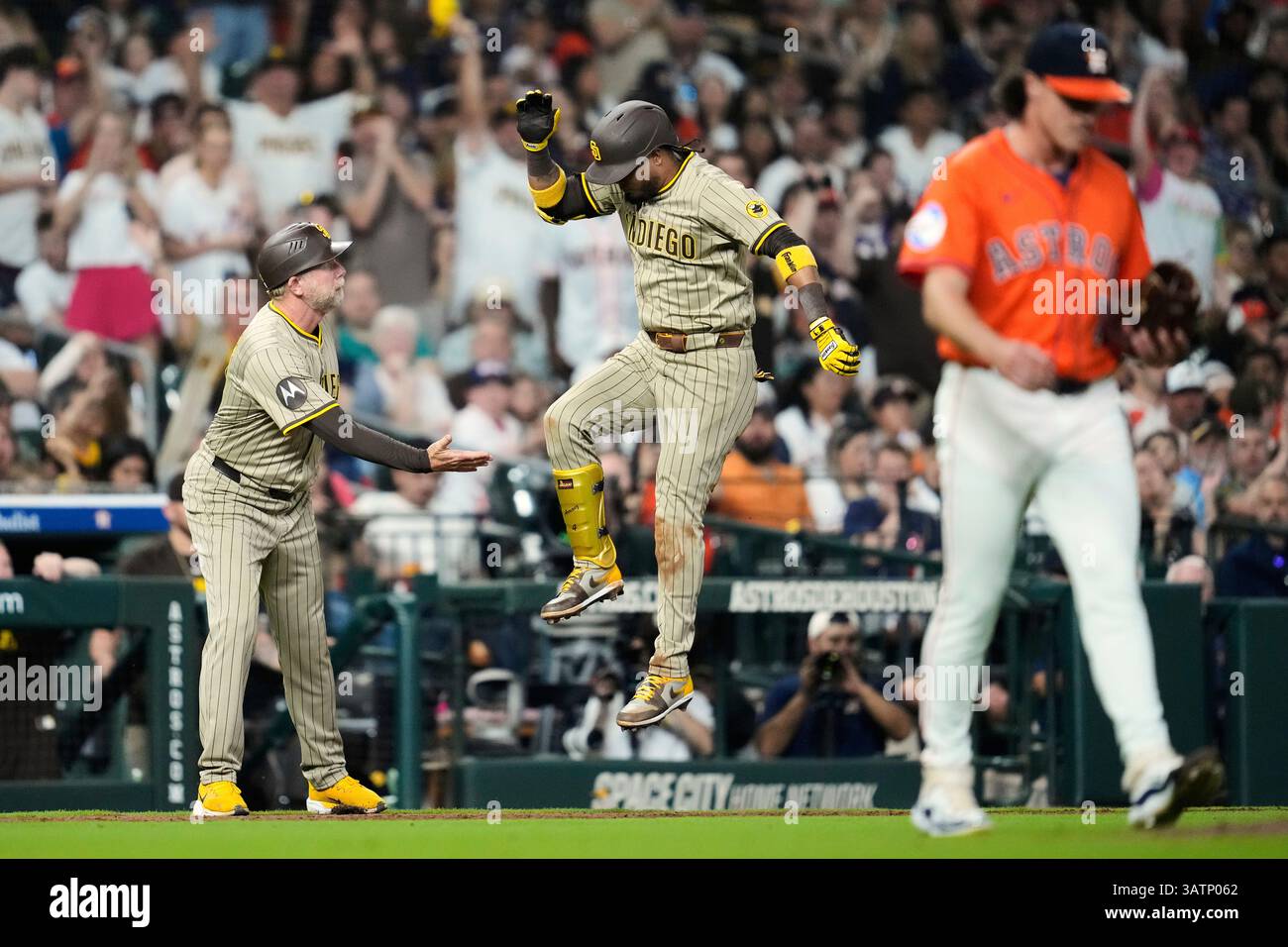 San Diego Padres' Luis Arraez, center, celebrates with third base coach ...