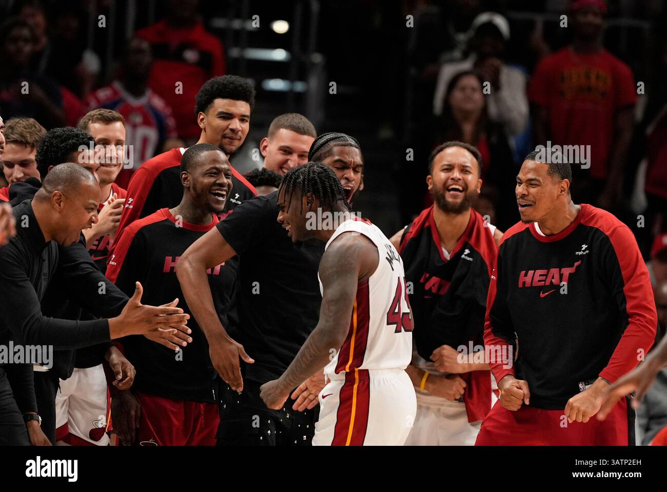 Miami Heat guard Davion Mitchell (45) cheers to the bench after scoring ...