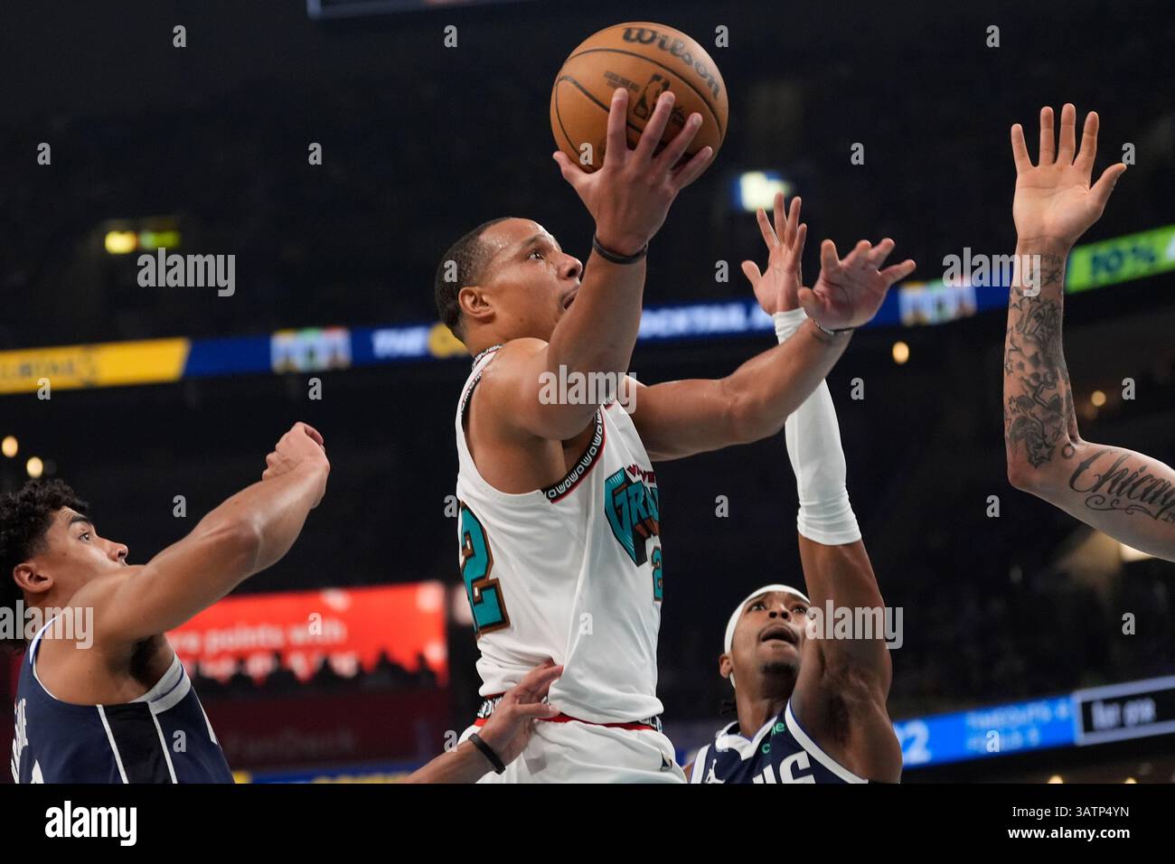 Memphis Grizzlies guard Desmond Bane, center, shoots the ball past ...