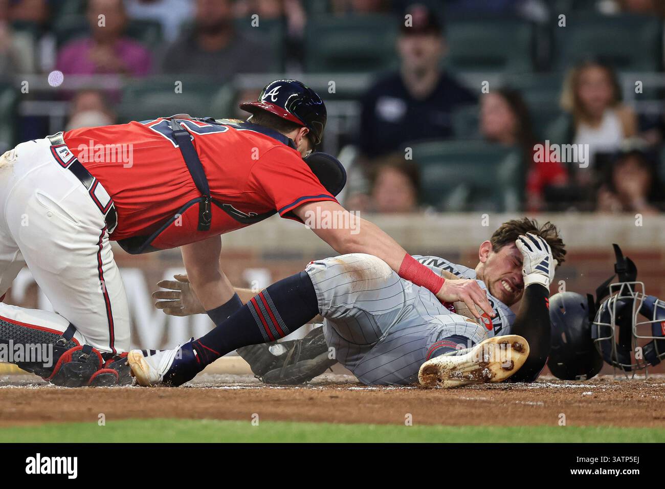 Atlanta Braves catcher Sean Murphy, left, tags out Minnesota Twins' Brooks Lee, right, at the ...