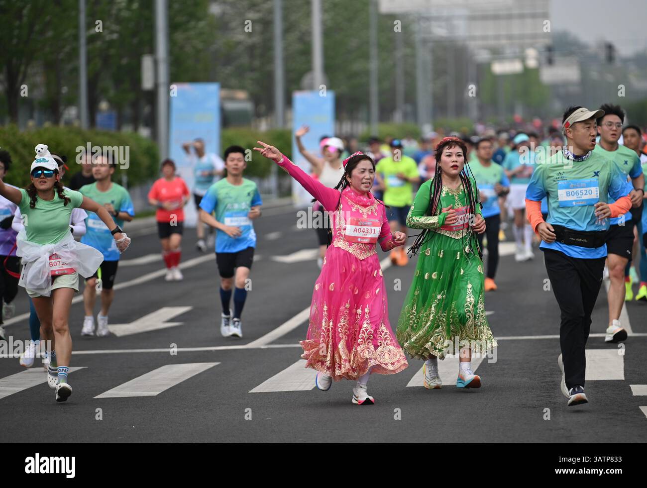 Peking, China. 19th Apr, 2025. Two women take part in a race in an ...