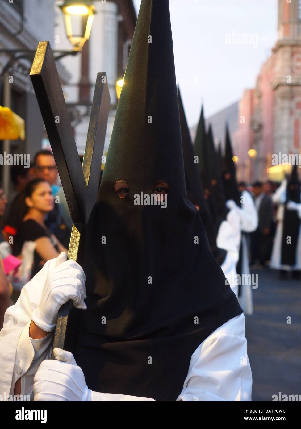Catholic devotees, Hooded and carrying a cross, carrying on a religious ...