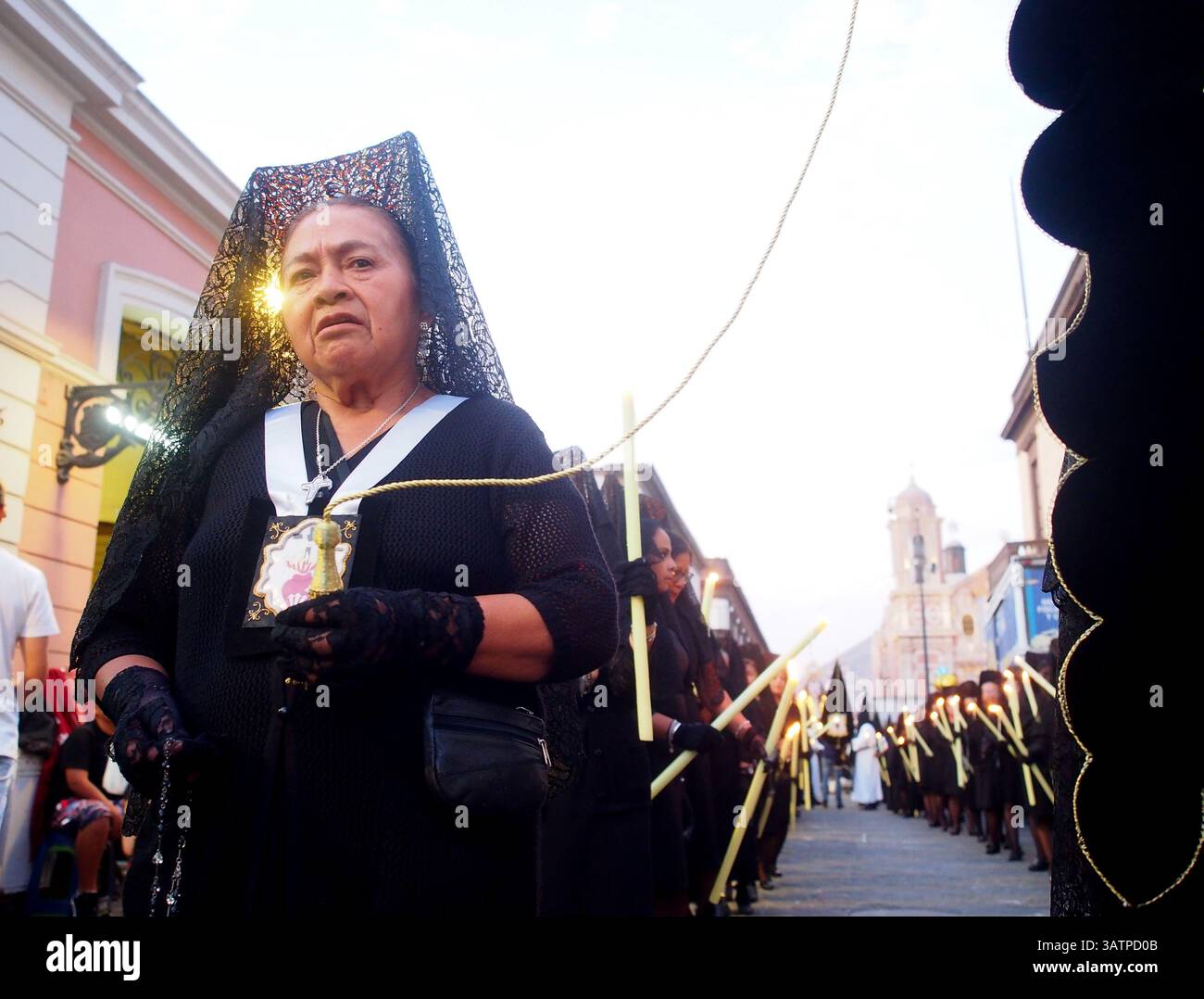 Black dressed female devotees wearing mantilla and comb, carrying ...