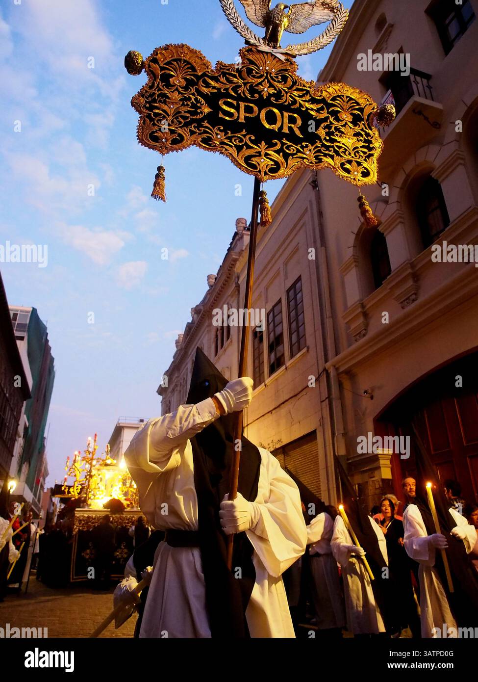 Catholic devotees, hooded carrying on a religious procession at eve on ...