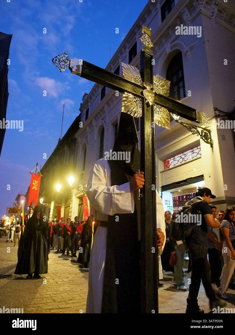 Catholic devotees, Hooded and carrying a cross, carrying on a religious ...