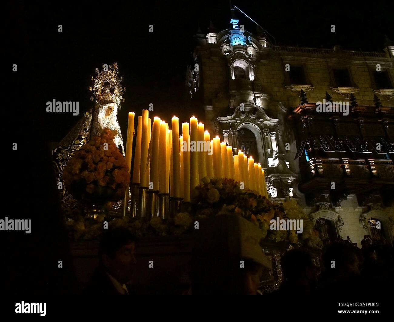 Catholic devotees, carrying a religious image participating on a ...