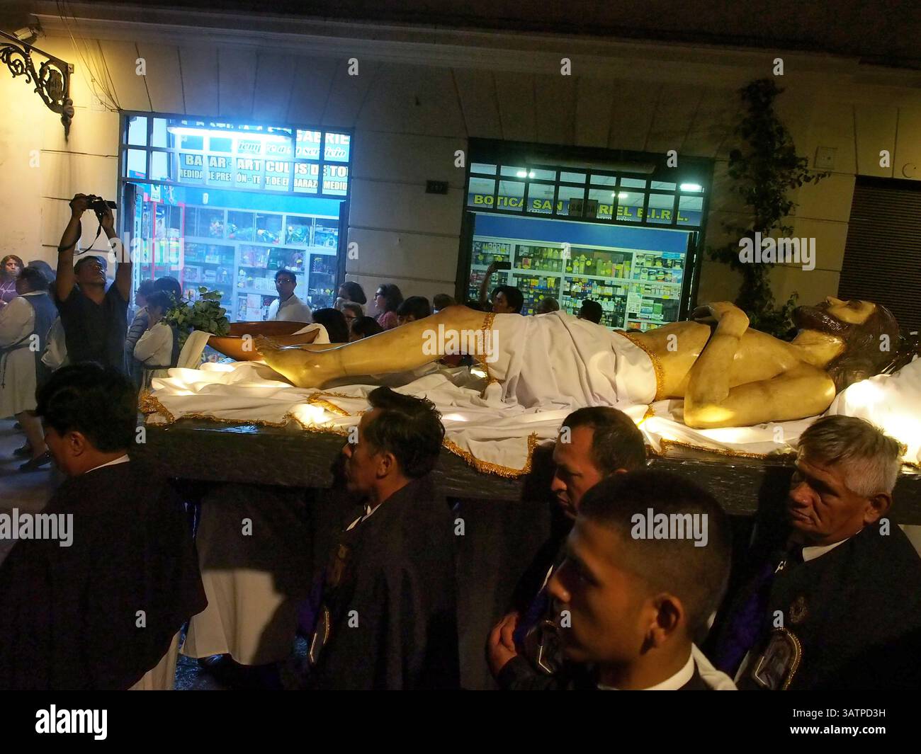 Catholic devotees carrying a recumbent Christ on a religious procession ...
