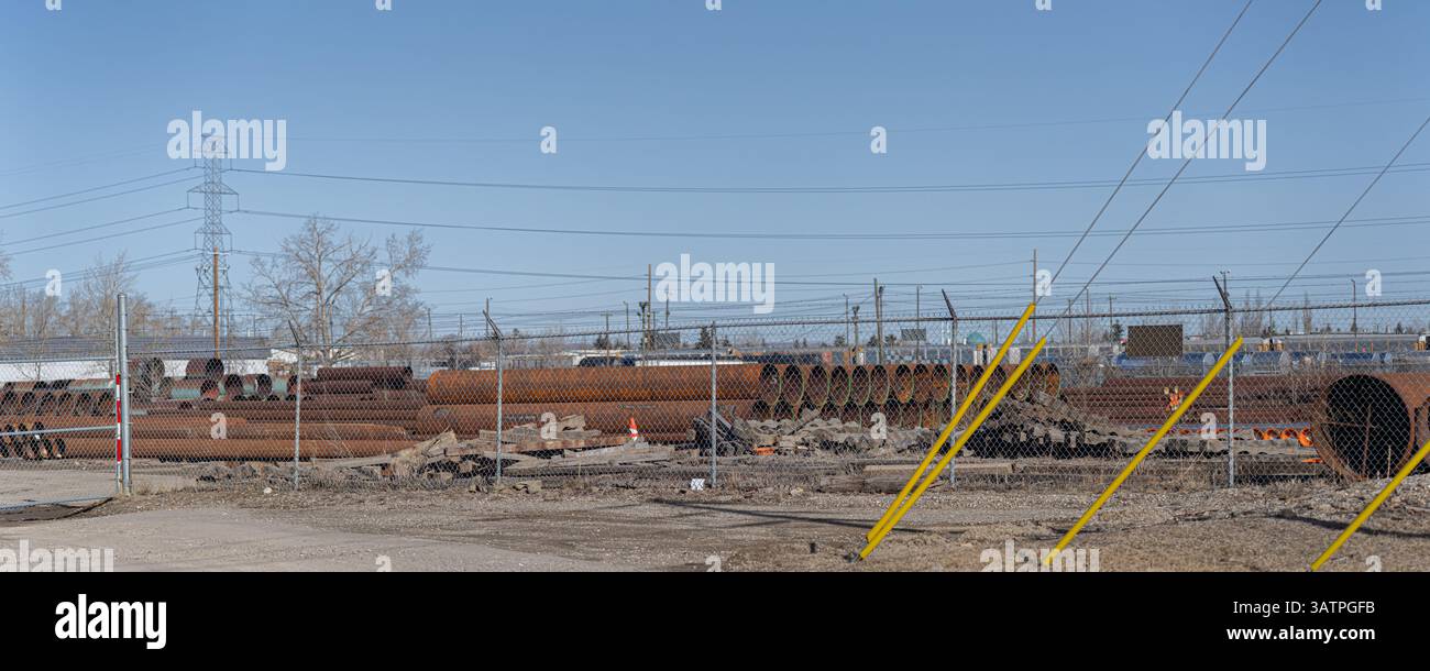 Industrial size pipes on display in a closed field Stock Photo - Alamy