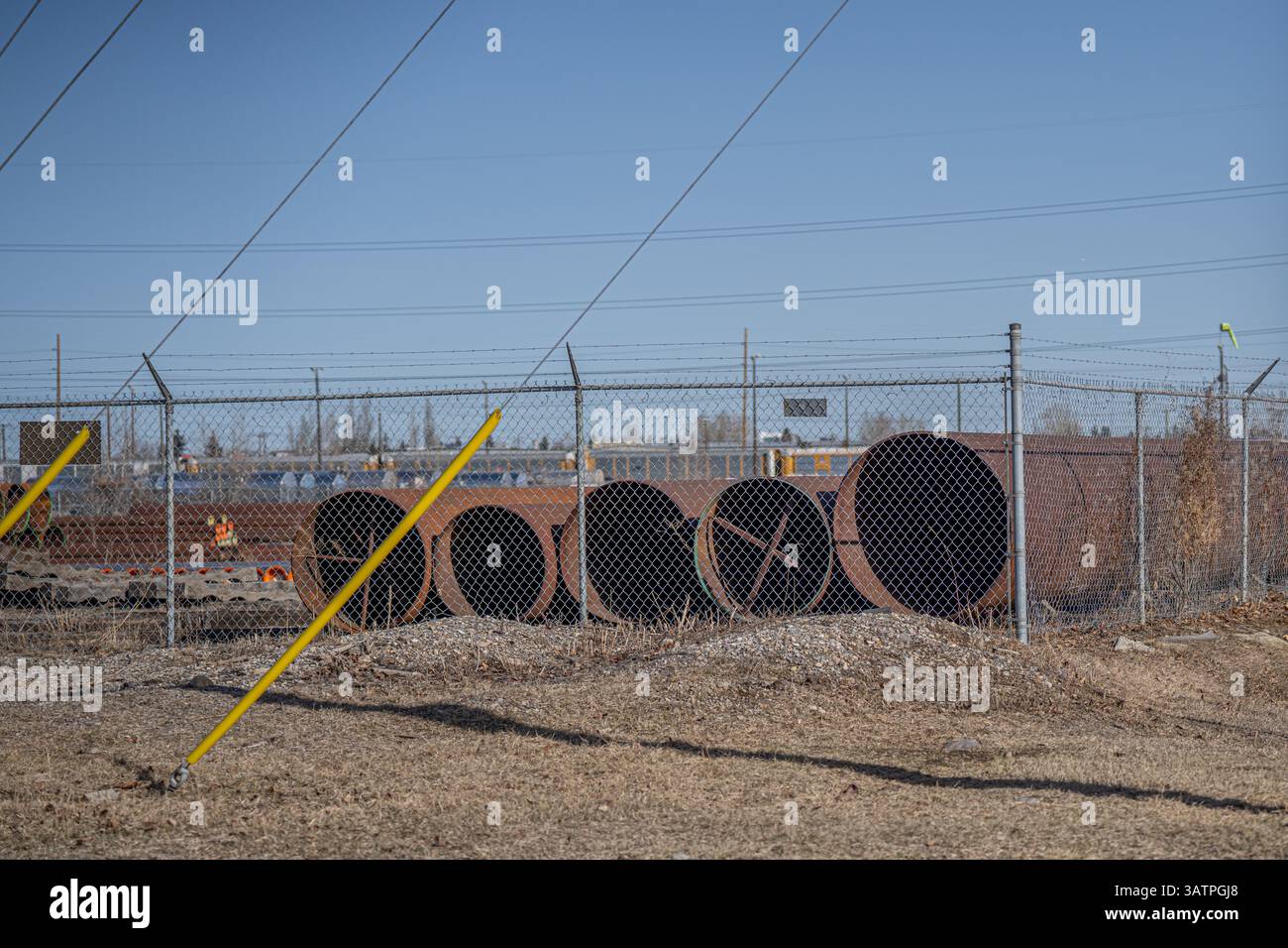 Industrial size pipes on display in a closed field Stock Photo - Alamy