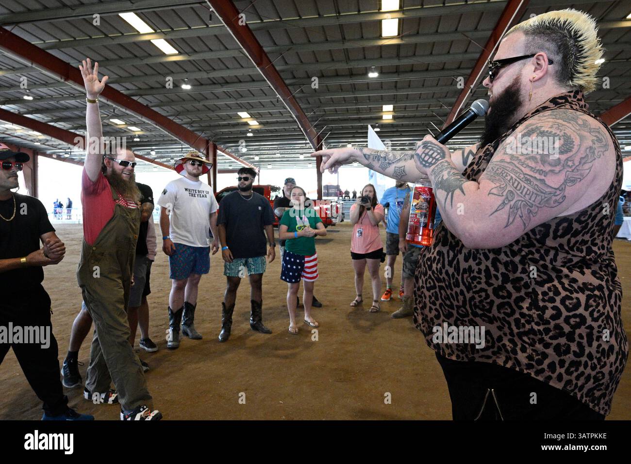 Mike Busey, right, picks spectators for his team during the Florida Man ...