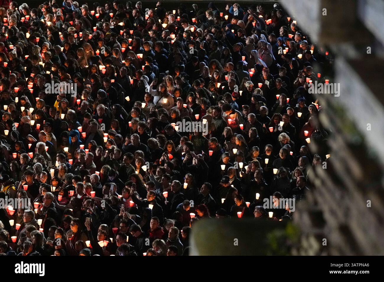 Faithful attend the Way of the Cross procession, inside the Colosseum ...